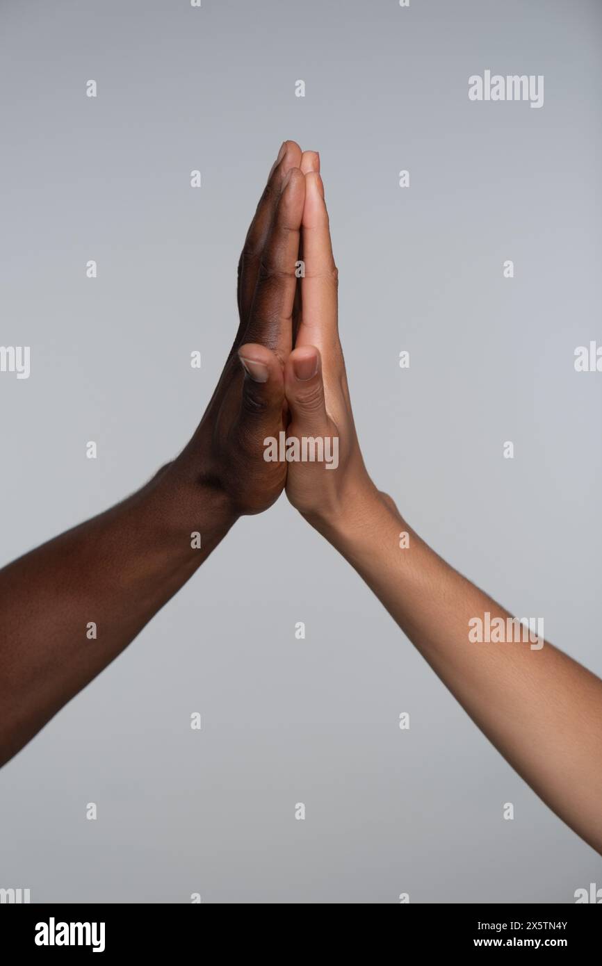 Couple holding hands palm to palm Stock Photo - Alamy
