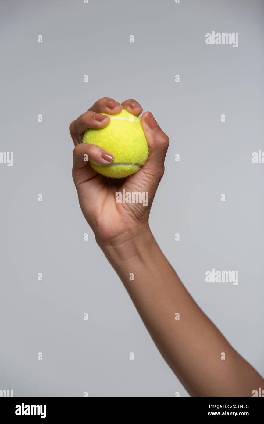 Woman holding tennis ball Stock Photo - Alamy