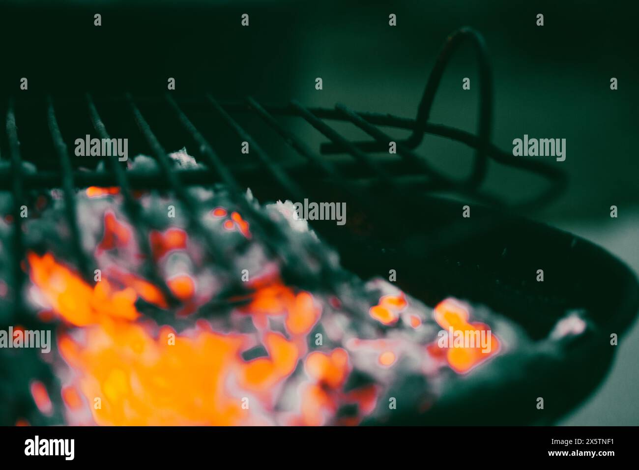 Barbecue coals smolder on the surface of a metal grate. Picnic in ...
