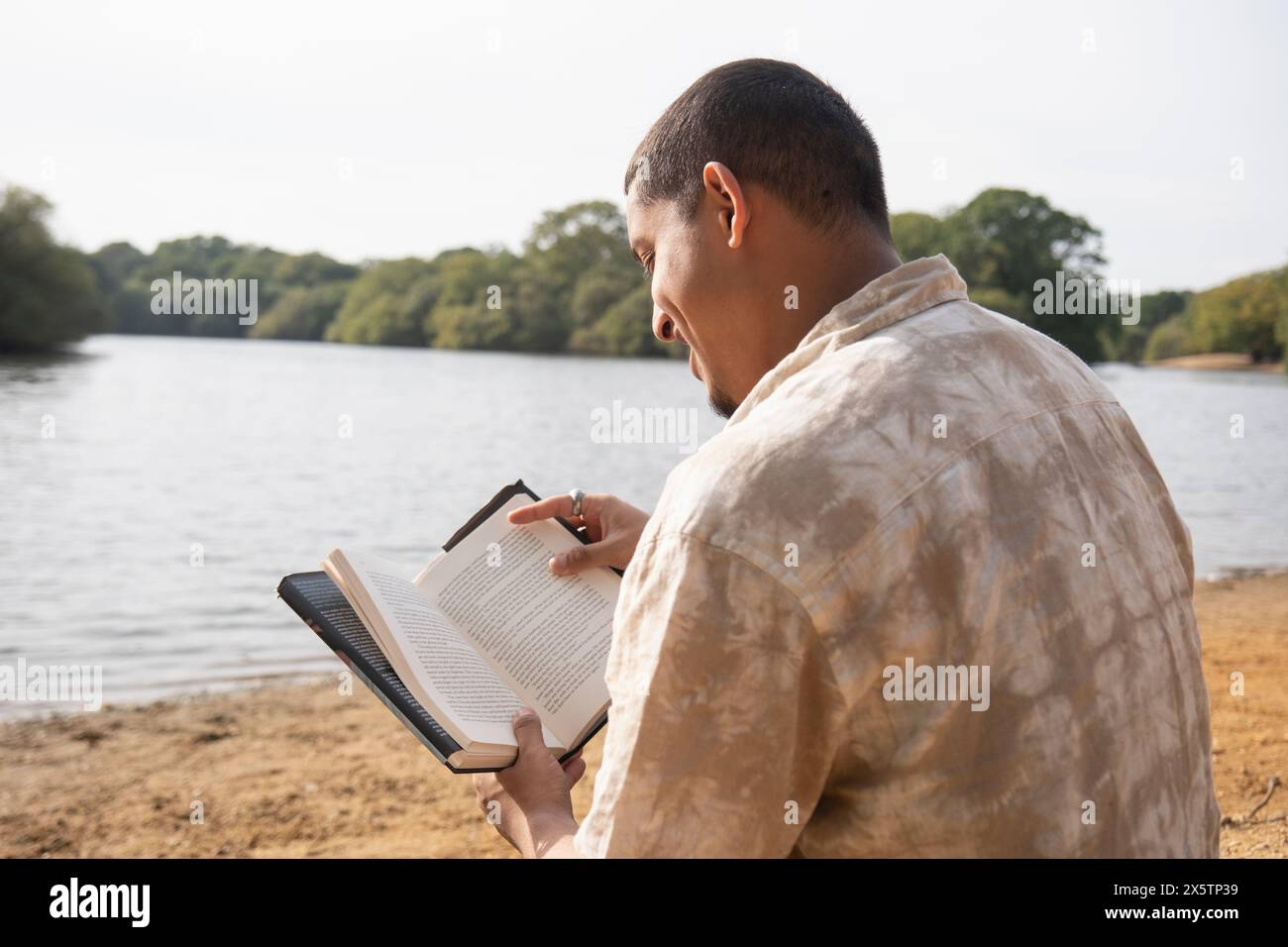 One man reading book hi-res stock photography and images - Alamy