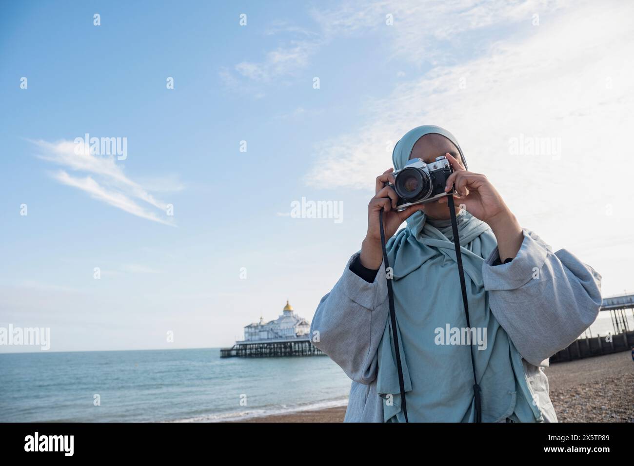 Portrait of Muslim woman photographing with analog camera Stock Photo ...