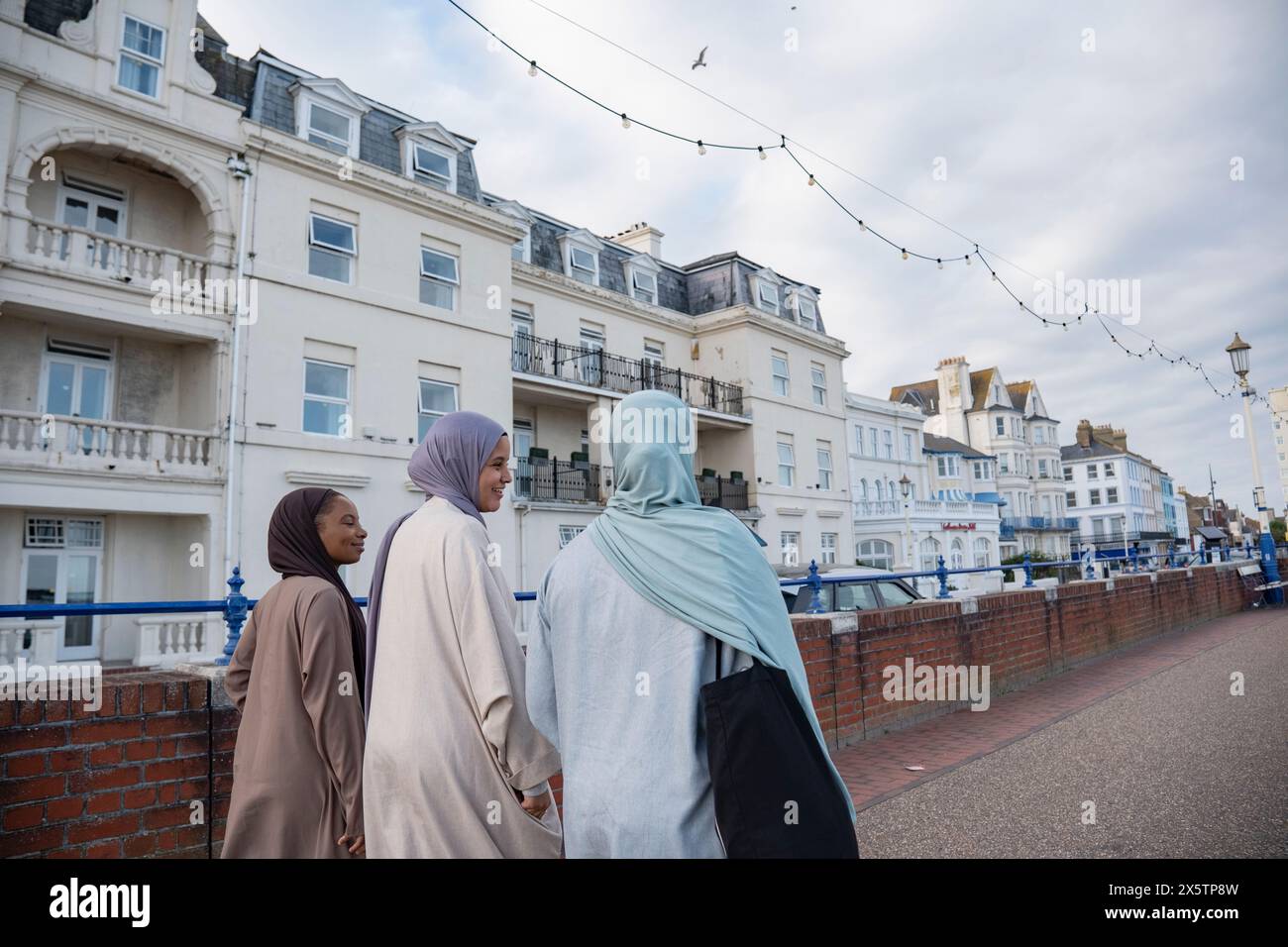 Rear view of three Muslim women walking in city Stock Photo - Alamy
