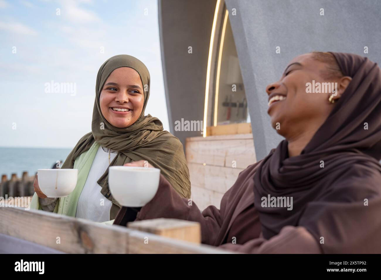 Laughing muslim women in hi-res stock photography and images - Alamy