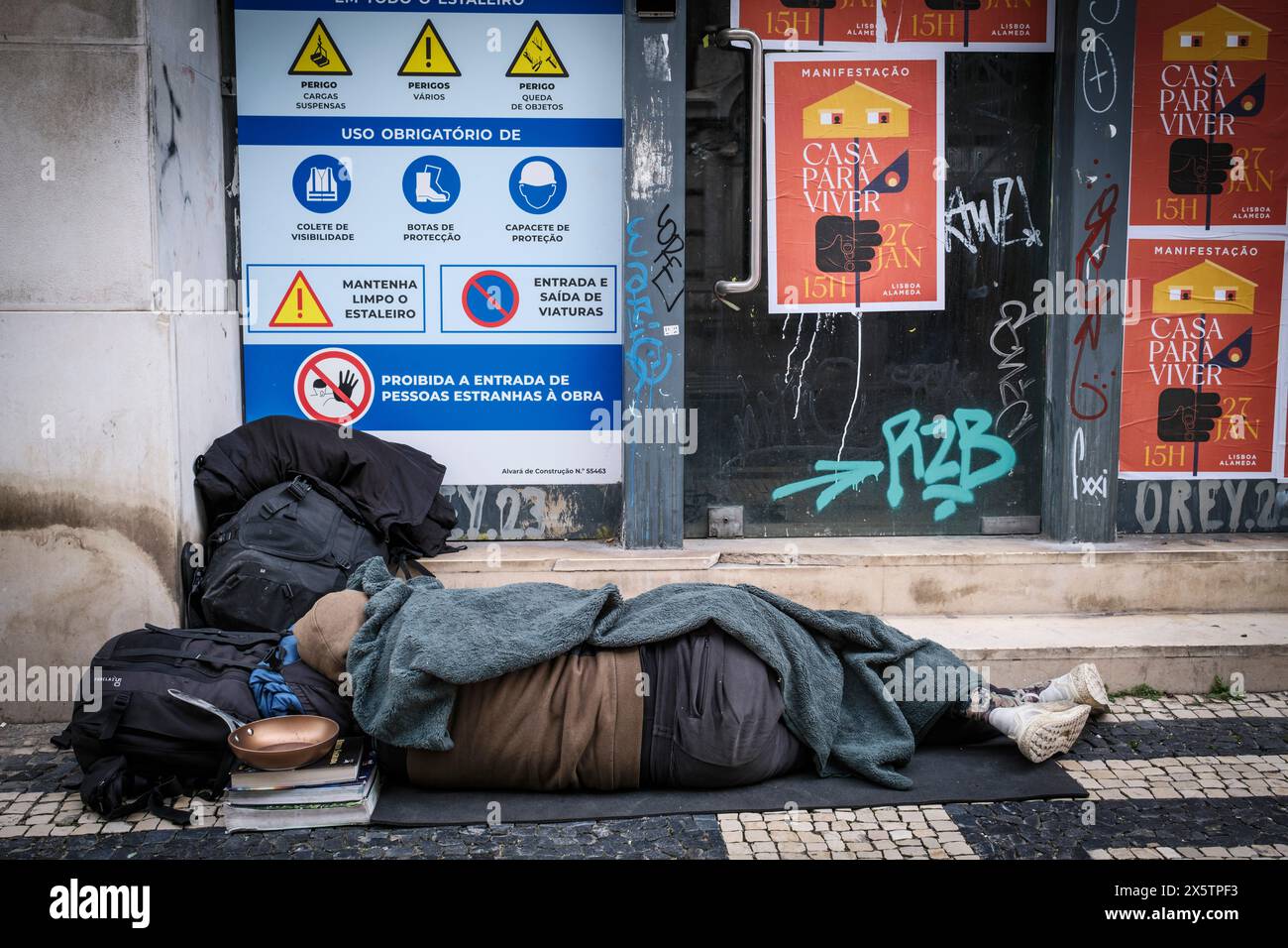 People watching in Lisbon, street photography - homeless man sleeping in old town near Praca ...