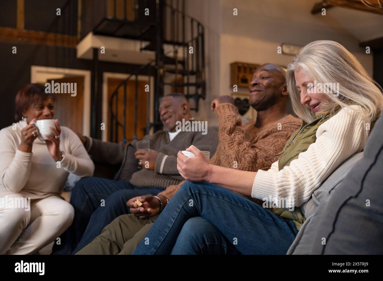 Friends sitting home on sofa hi-res stock photography and images - Alamy