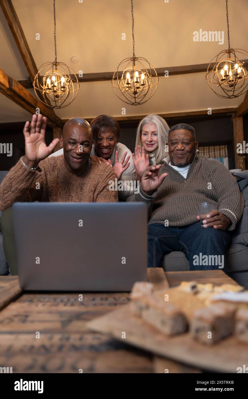 Friends waving during video conference at home Stock Photo - Alamy