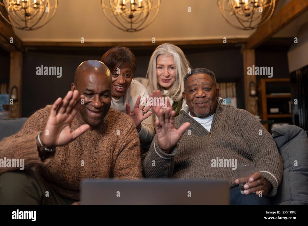 Friends waving during video conference at home Stock Photo - Alamy