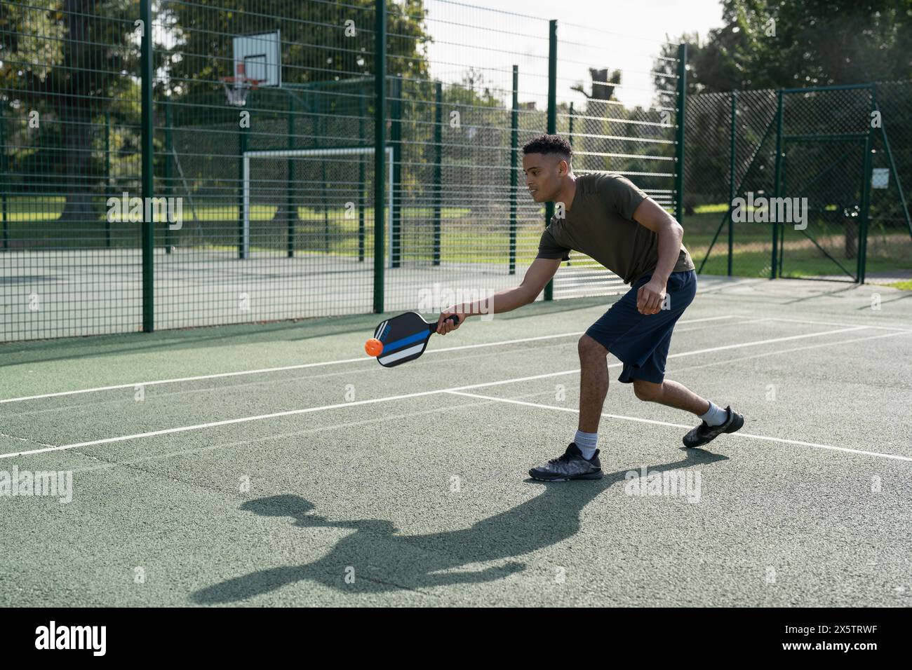 Man playing pickleball Stock Photo - Alamy