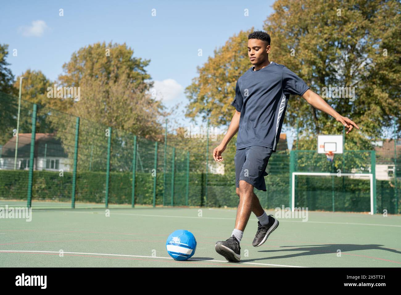 Man playing soccer Stock Photo - Alamy