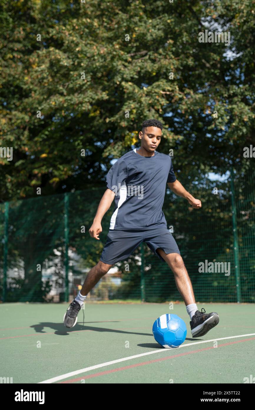 Man playing soccer Stock Photo - Alamy