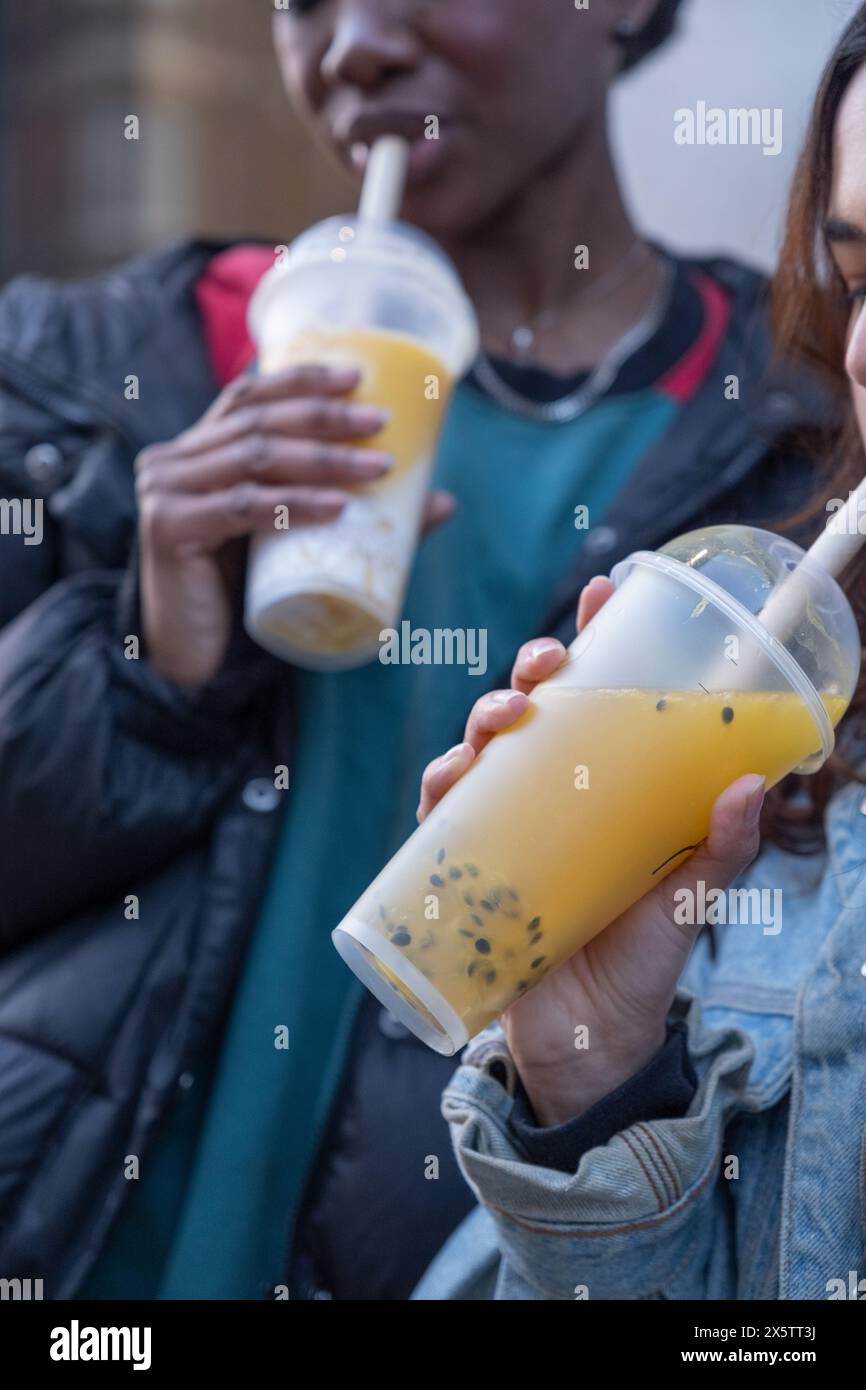 Close up of two women drinking bubble tea Stock Photo - Alamy