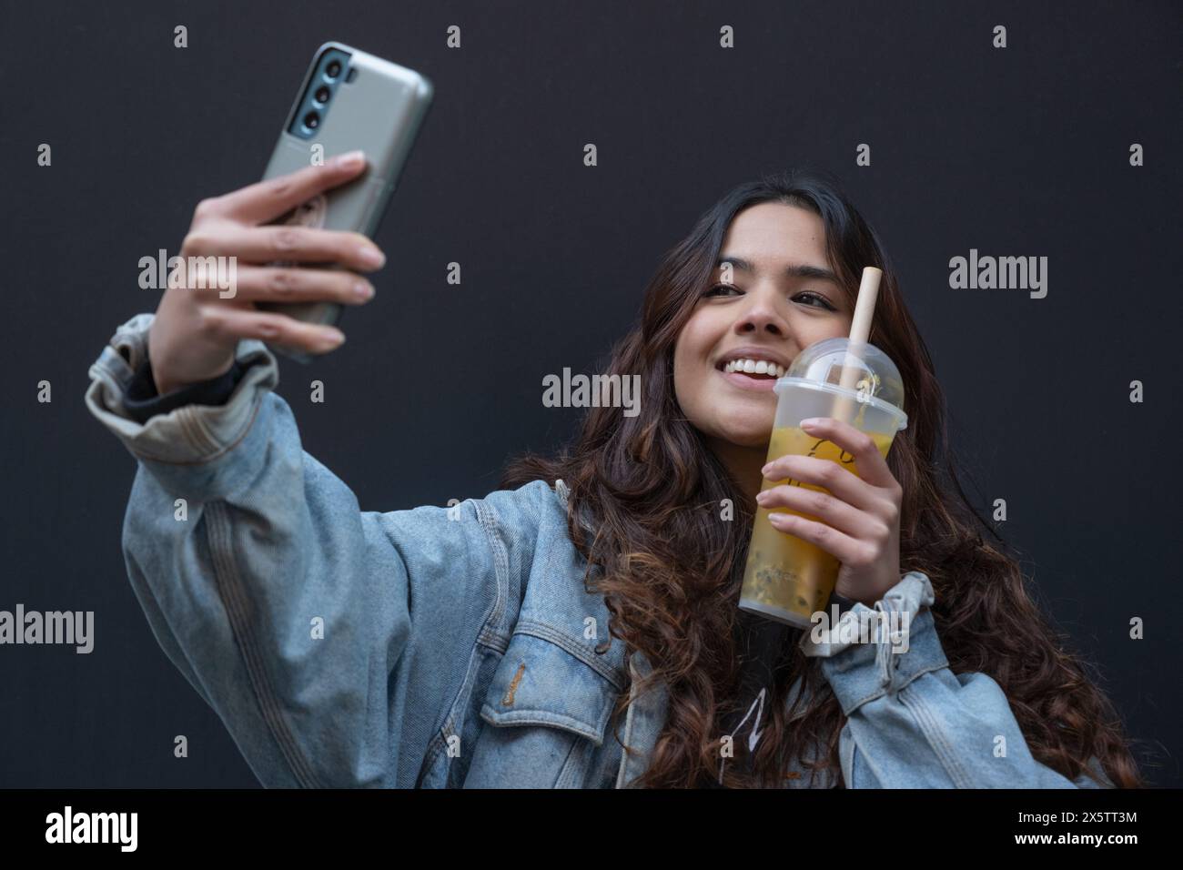Young woman taking selfie while holding bubble tea Stock Photo - Alamy