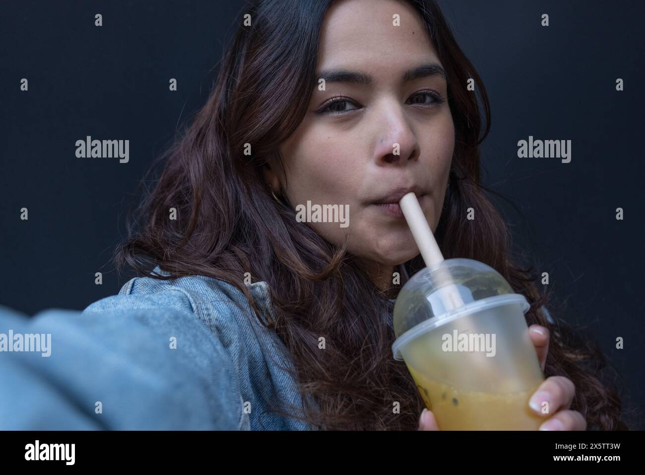Portrait of cheerful young woman drinking bubble tea Stock Photo - Alamy
