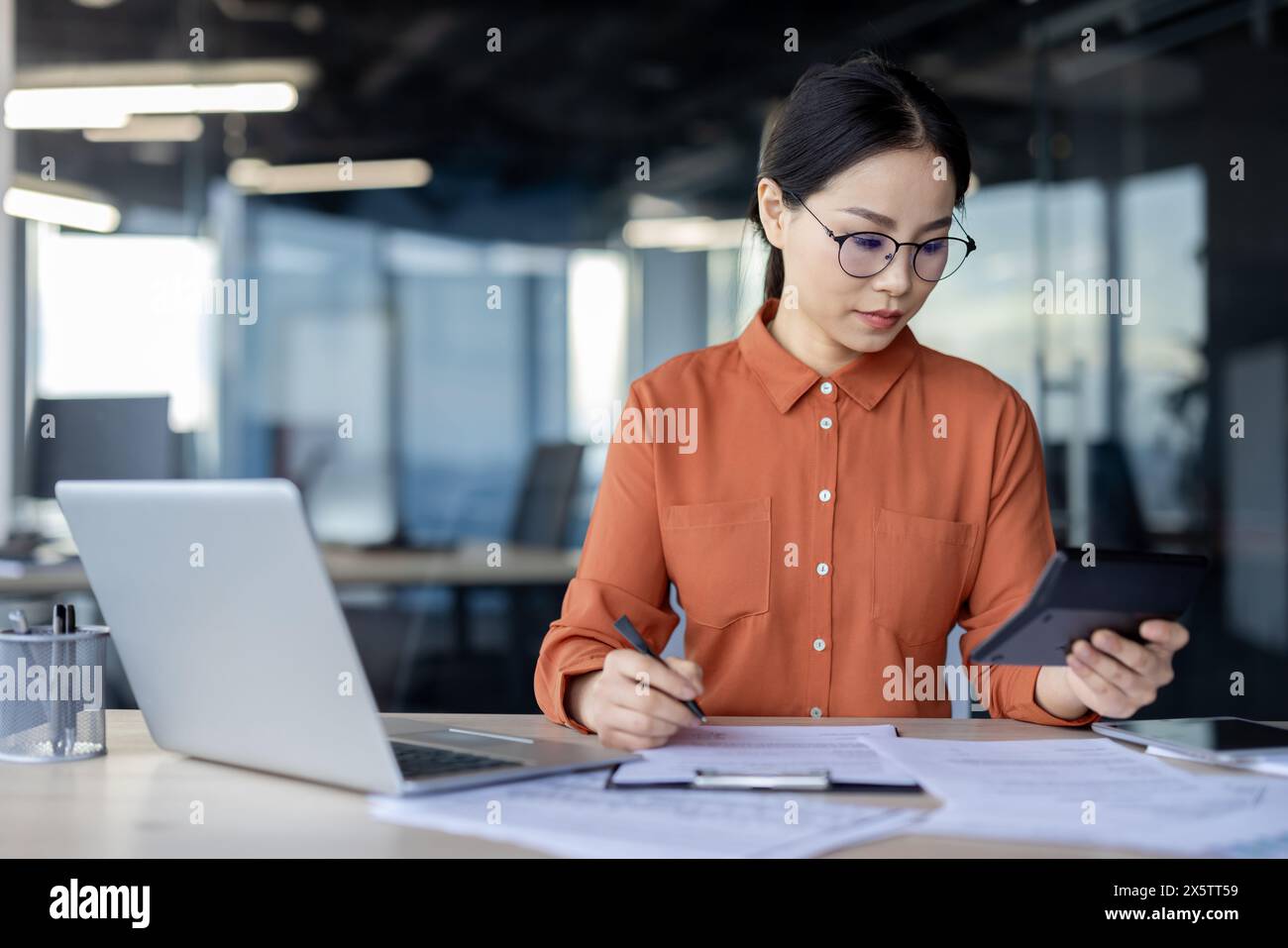 Focused female accountant calculating numbers hi-res stock photography ...