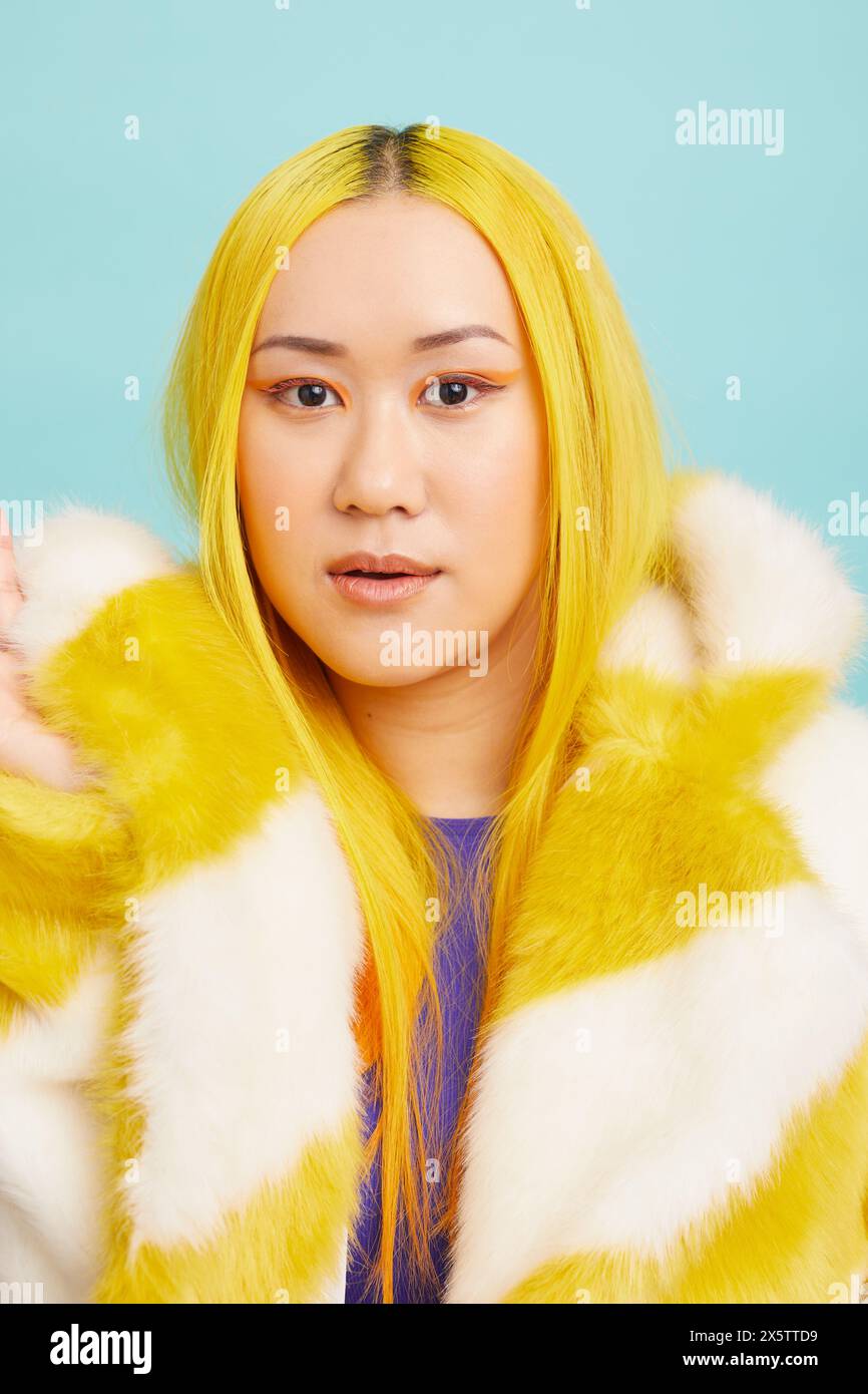 Woman with long yellow hair, wearing fur coat Stock Photo - Alamy