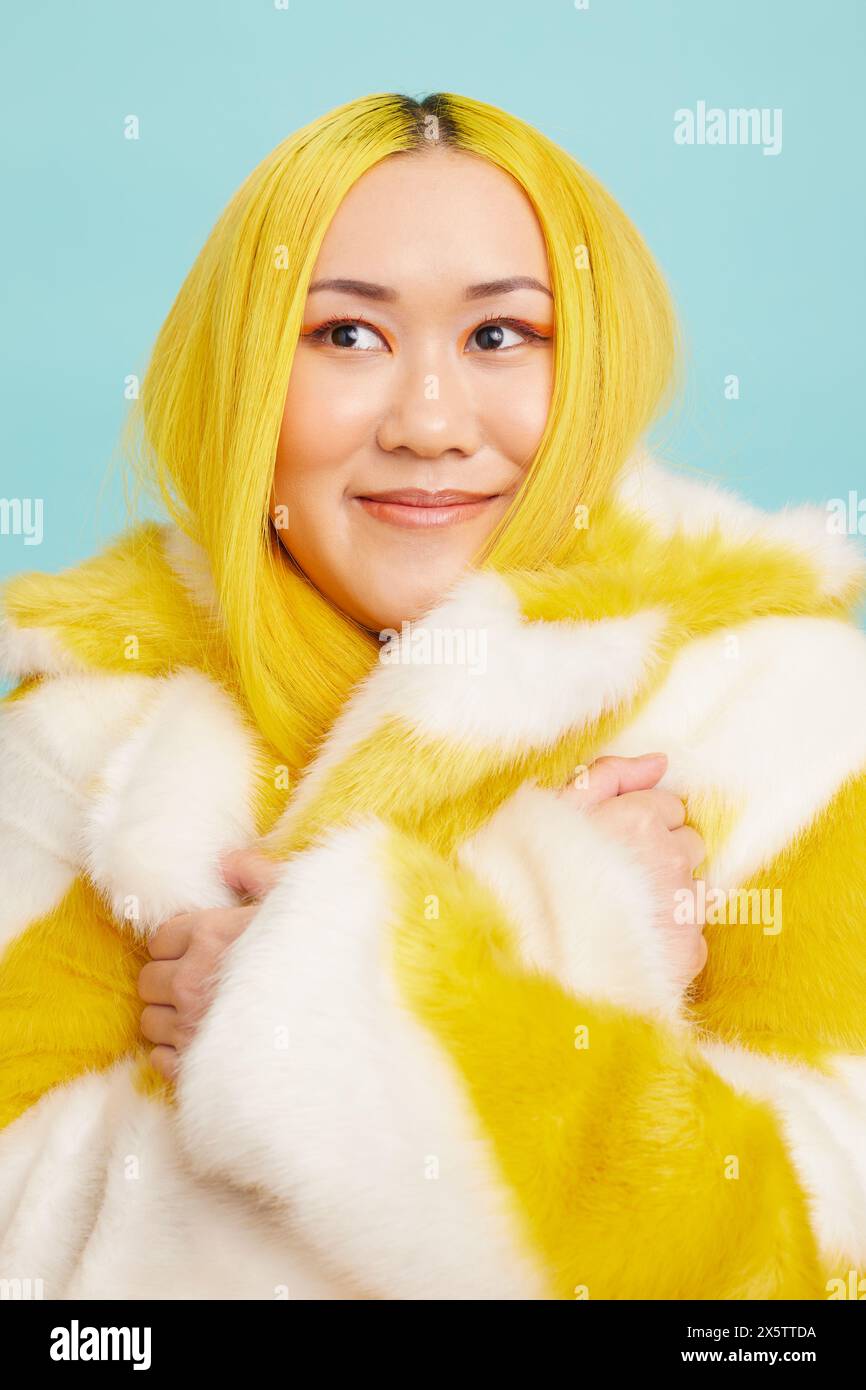 Woman with long yellow hair, wearing fur coat Stock Photo - Alamy