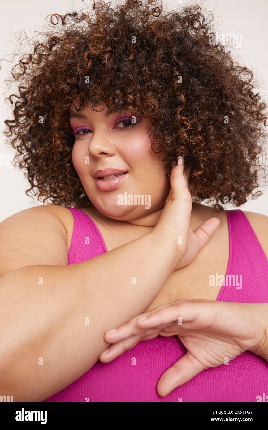 Portrait of brunette woman touching hair Stock Photo - Alamy