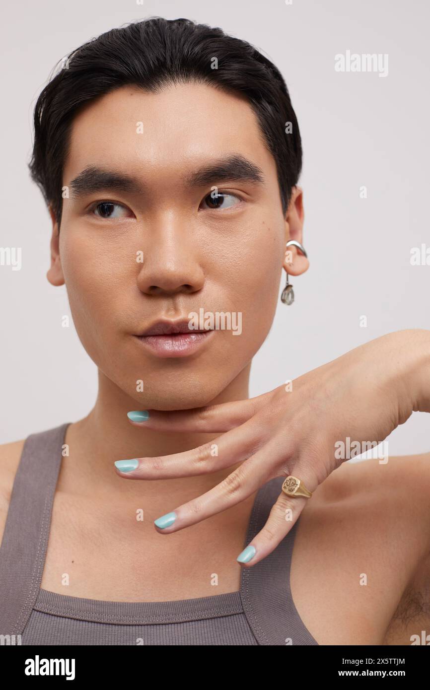 Studio portrait of handsome man with ear piercing Stock Photo - Alamy