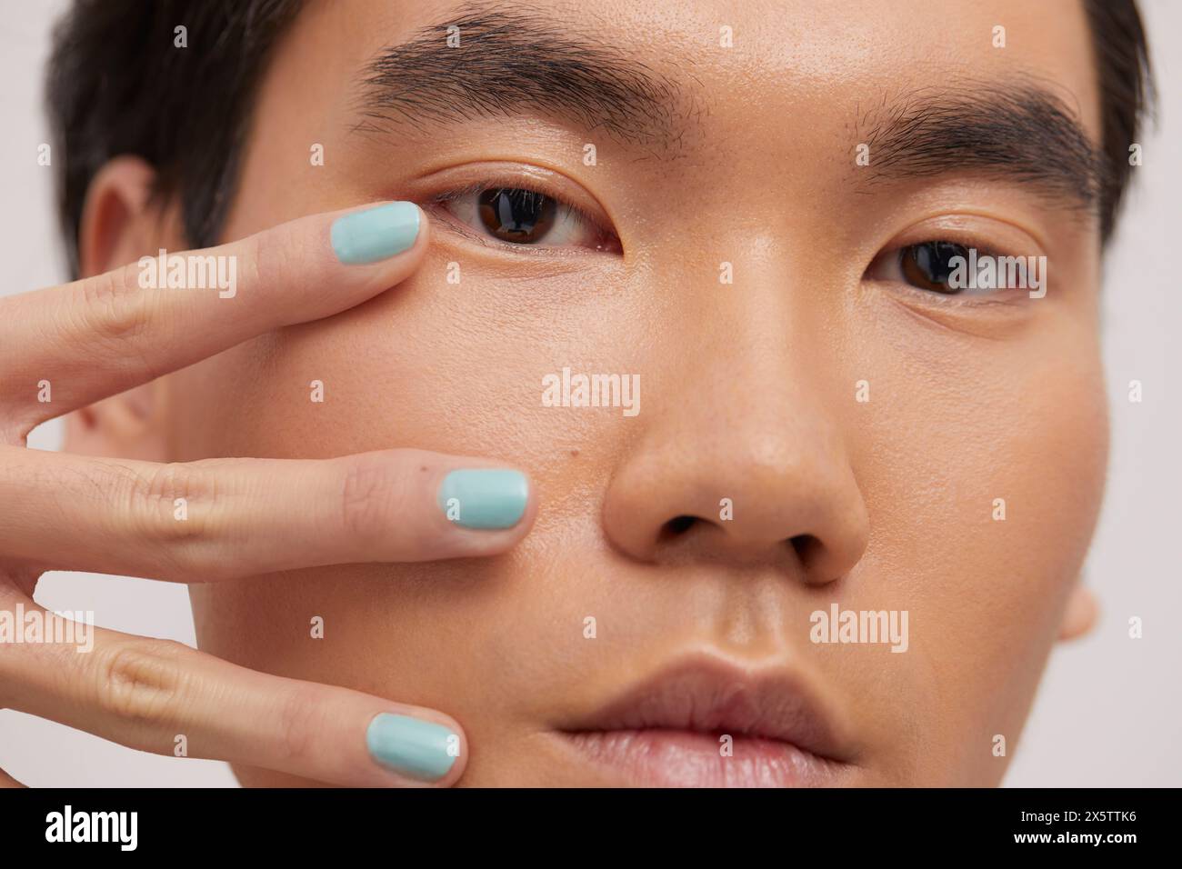 Studio portrait of handsome man with colored nails Stock Photo - Alamy