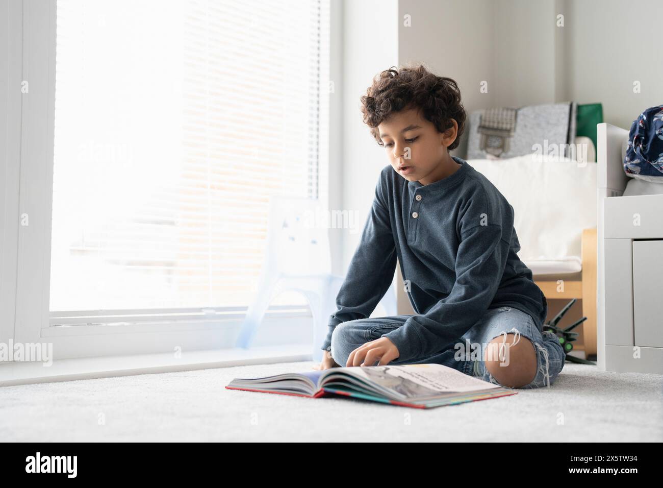 Boy reading book home hi-res stock photography and images - Alamy