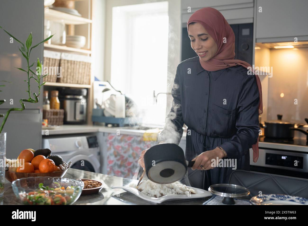 Hijab woman cooking home hi-res stock photography and images - Alamy