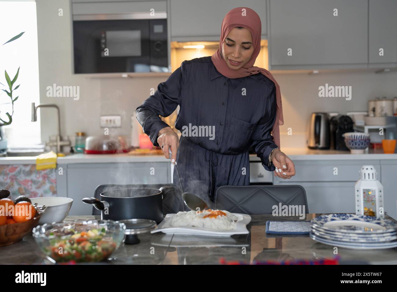 Hijab woman cooking home hi-res stock photography and images - Alamy