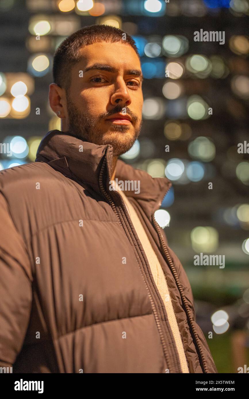 Portrait of young man standing outdoors at night Stock Photo - Alamy