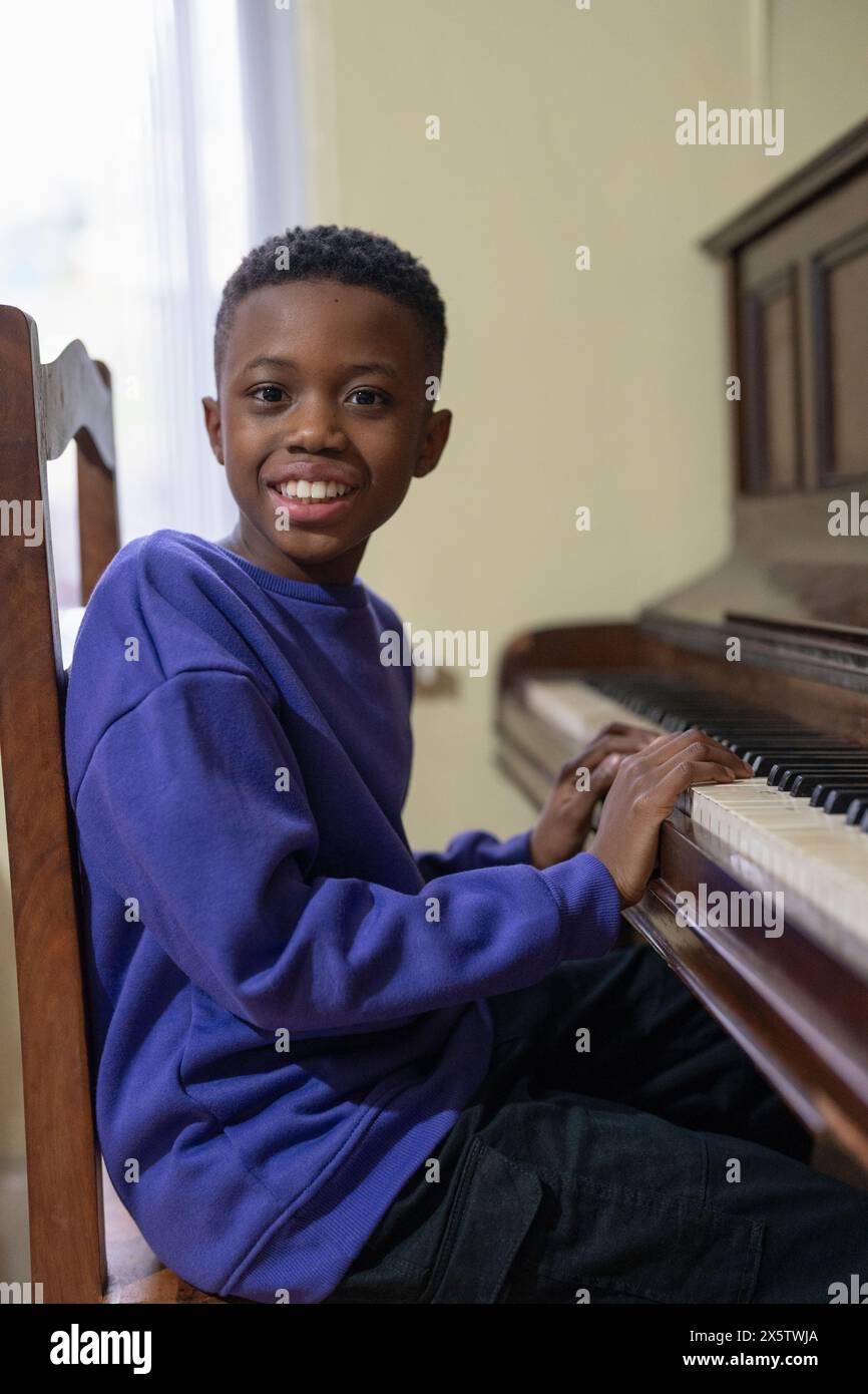 Boy playing piano at home Stock Photo - Alamy
