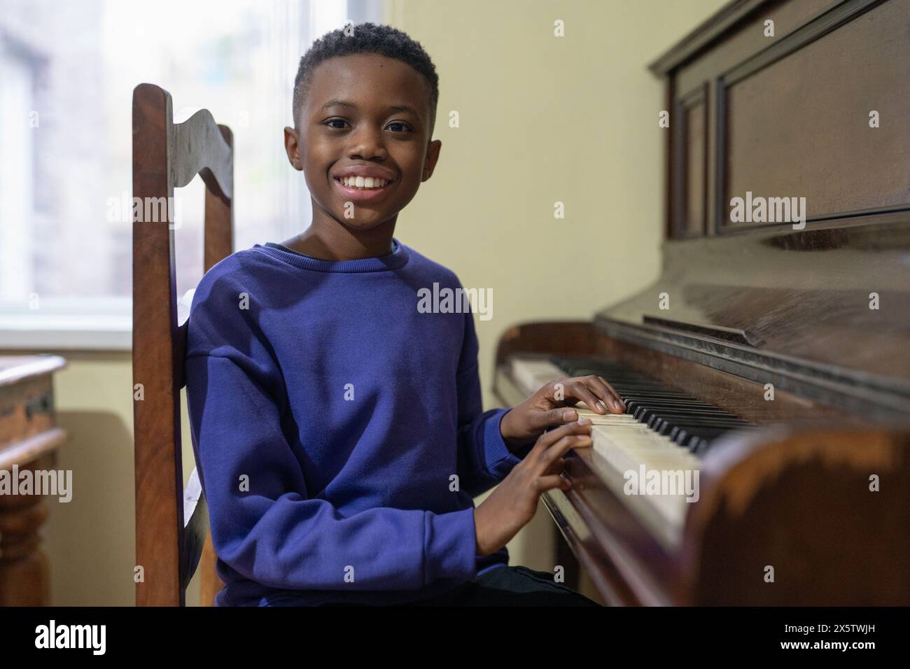 African boy playing piano hi-res stock photography and images - Alamy