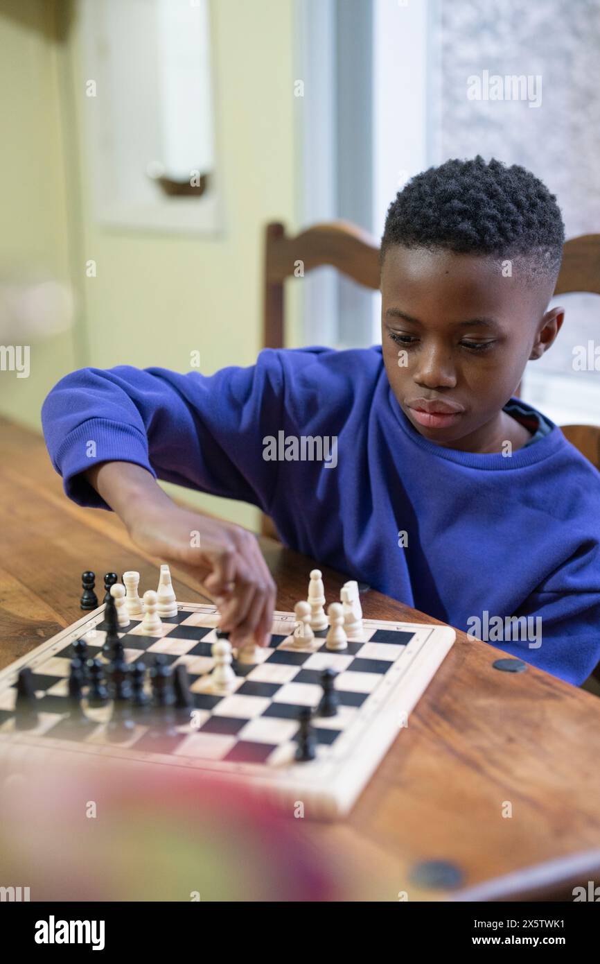 Boy playing chess at home Stock Photo - Alamy