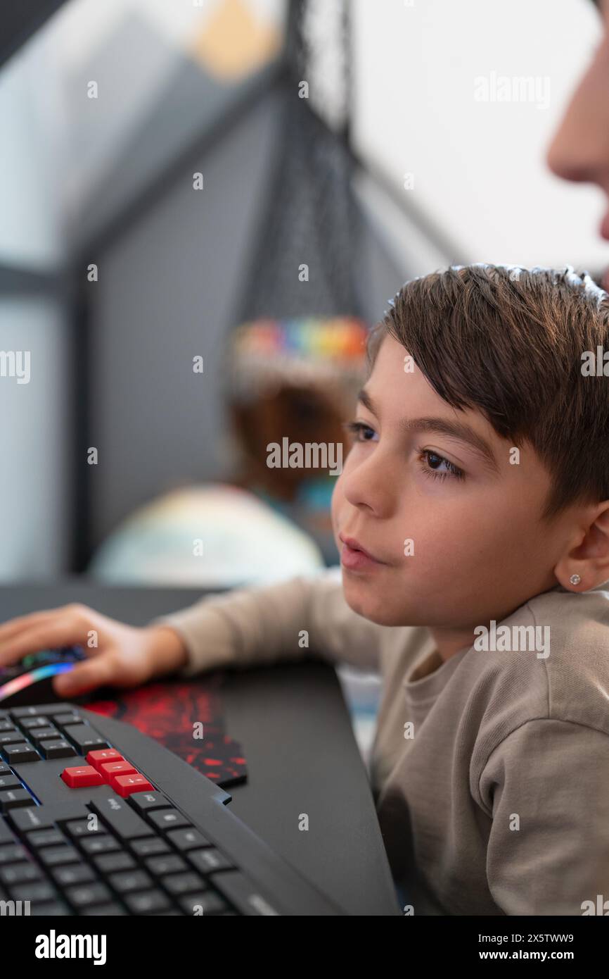Boy using computer at home hi-res stock photography and images - Alamy