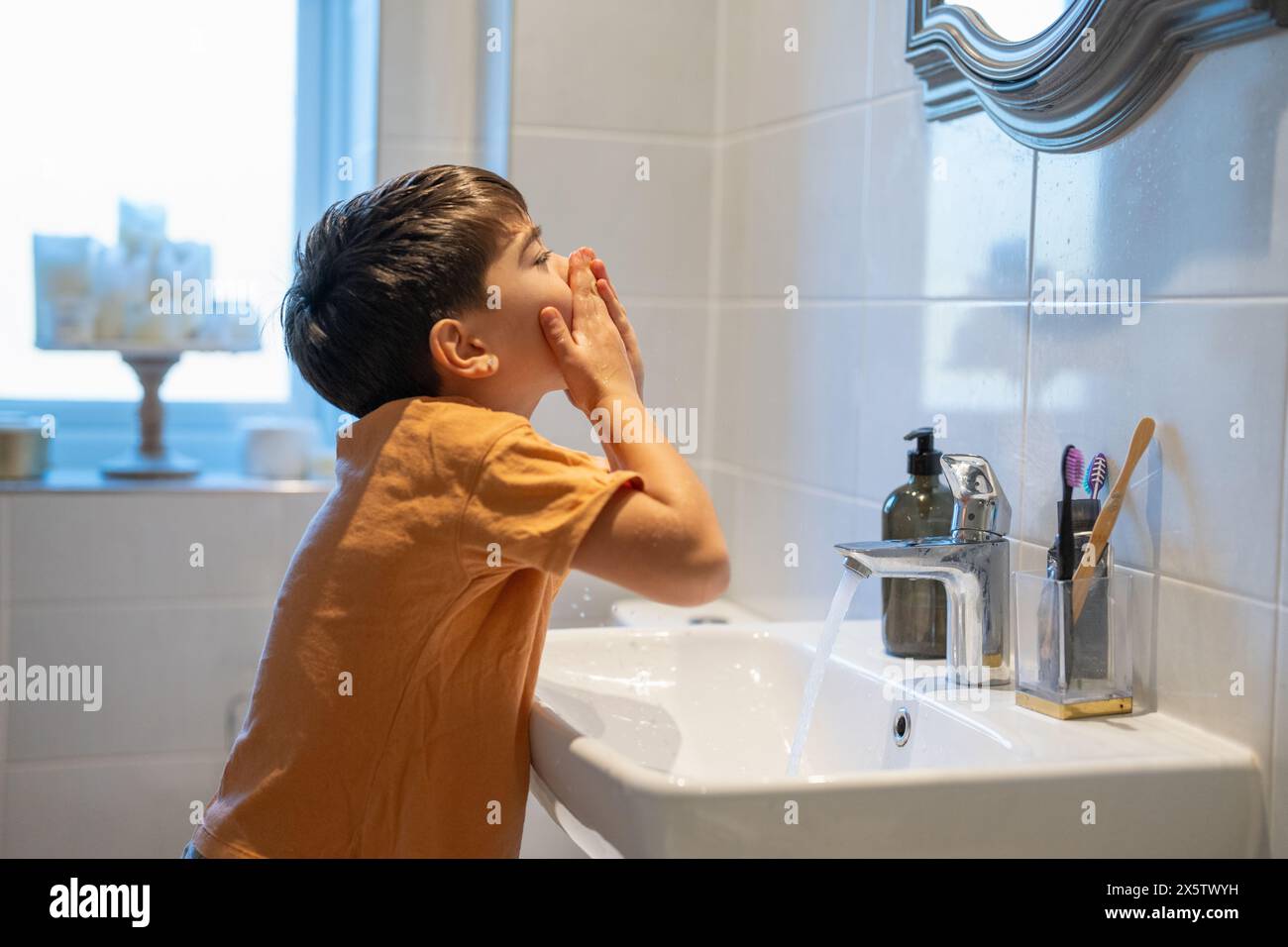 Boy washing face sink hi-res stock photography and images - Alamy