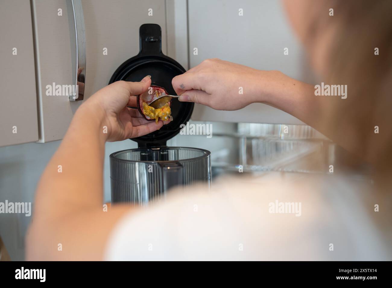 Woman using blender in kitchen Stock Photo - Alamy