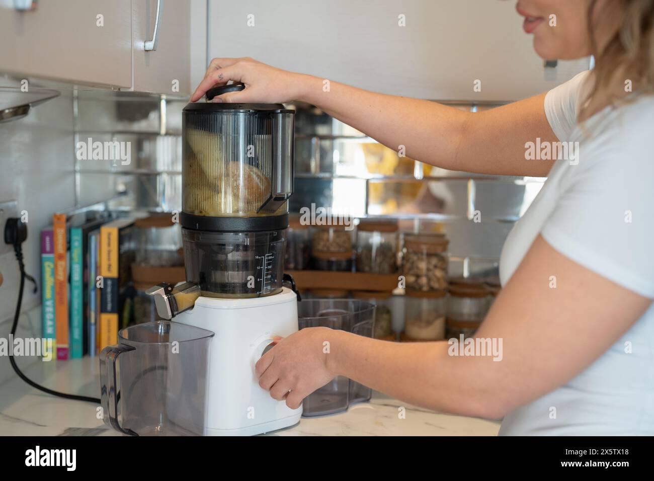 Woman using blender in kitchen Stock Photo - Alamy