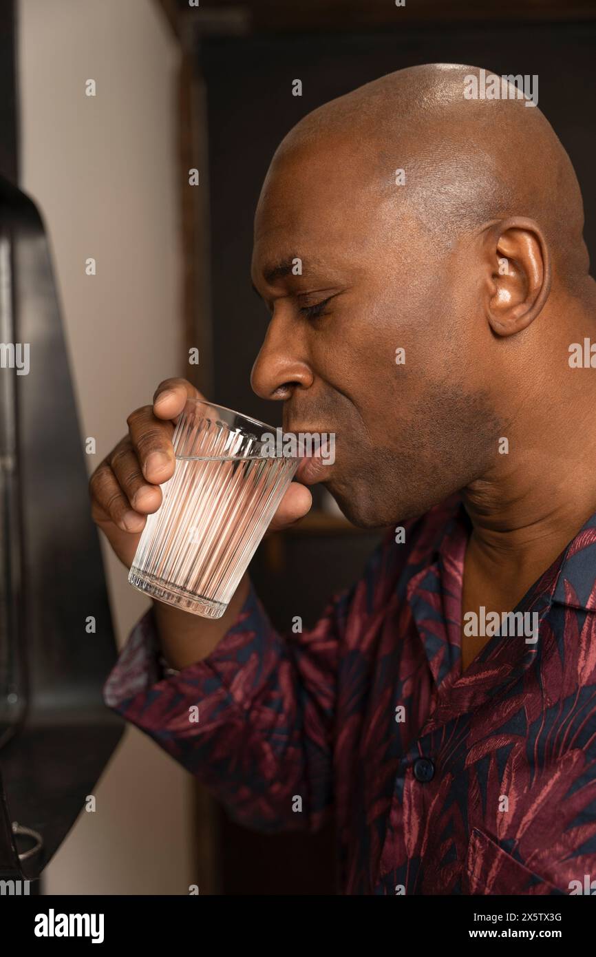 Man drinking glass of water while Stock Photo - Alamy