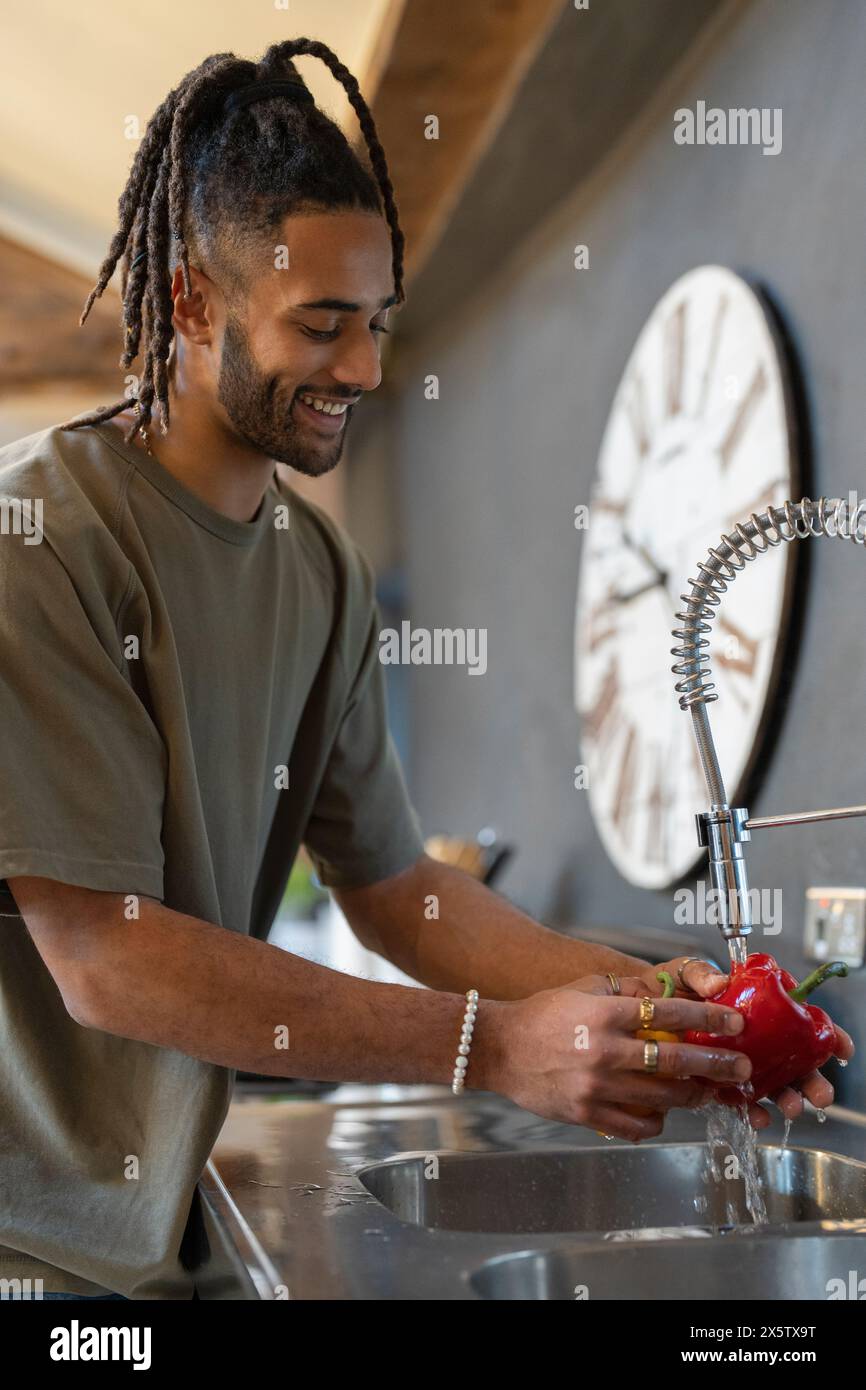 Men with dreads washing vegetables Stock Photo - Alamy