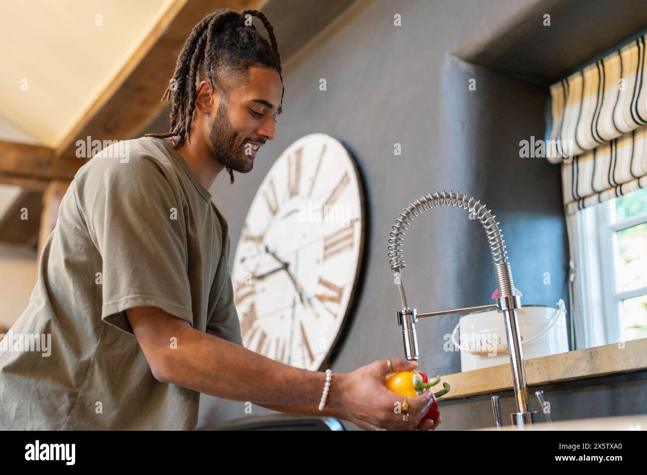 Men with dreads washing vegetables Stock Photo - Alamy