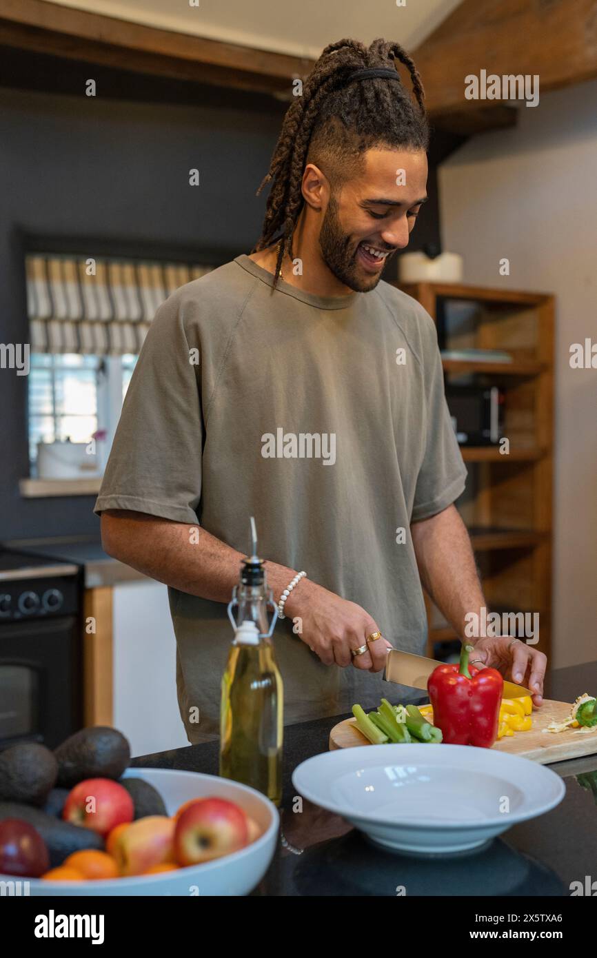 Men with dreads cutting vegetables in kitchen Stock Photo - Alamy