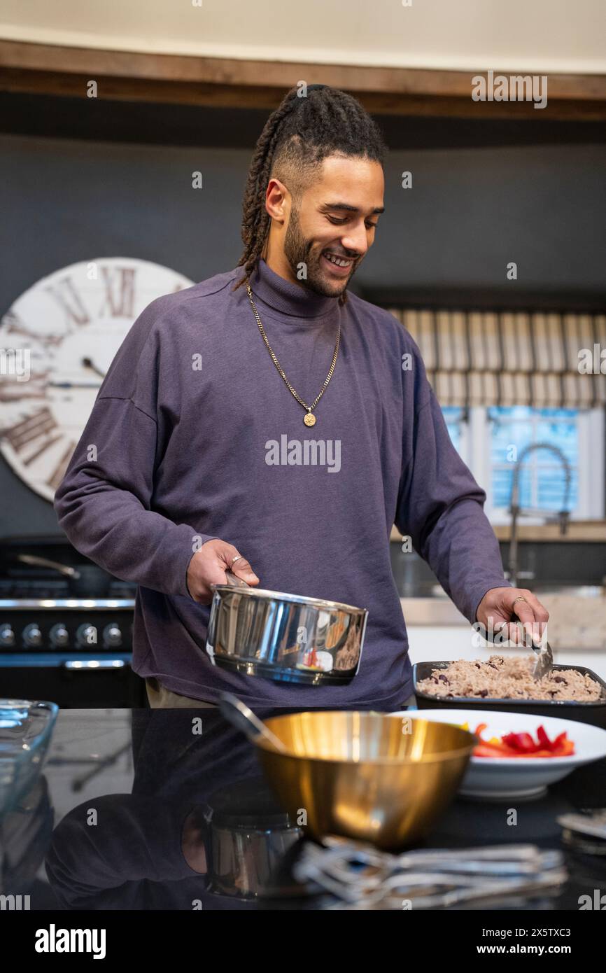 Kitchen young black man cooking hi-res stock photography and images - Alamy