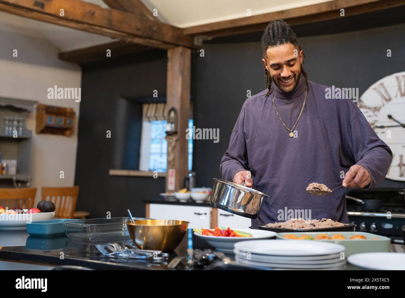 Kitchen young black man cooking hi-res stock photography and images - Alamy