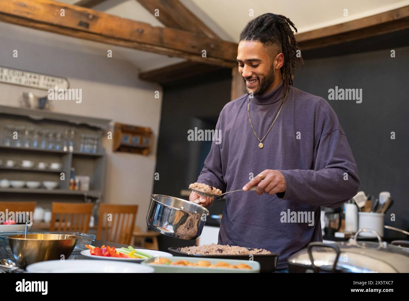 Kitchen young black man cooking hi-res stock photography and images - Alamy