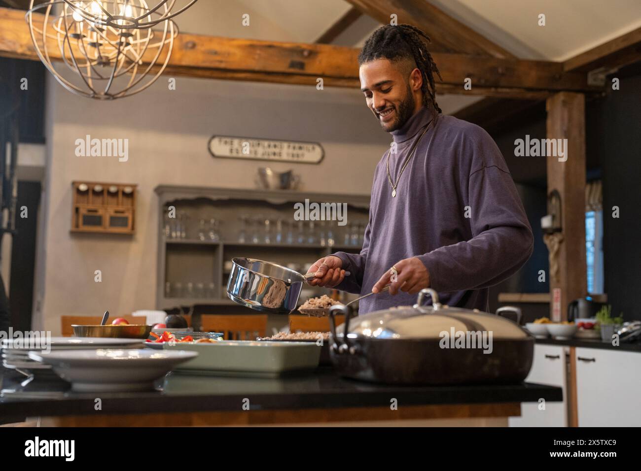 Kitchen young black man cooking hi-res stock photography and images - Alamy