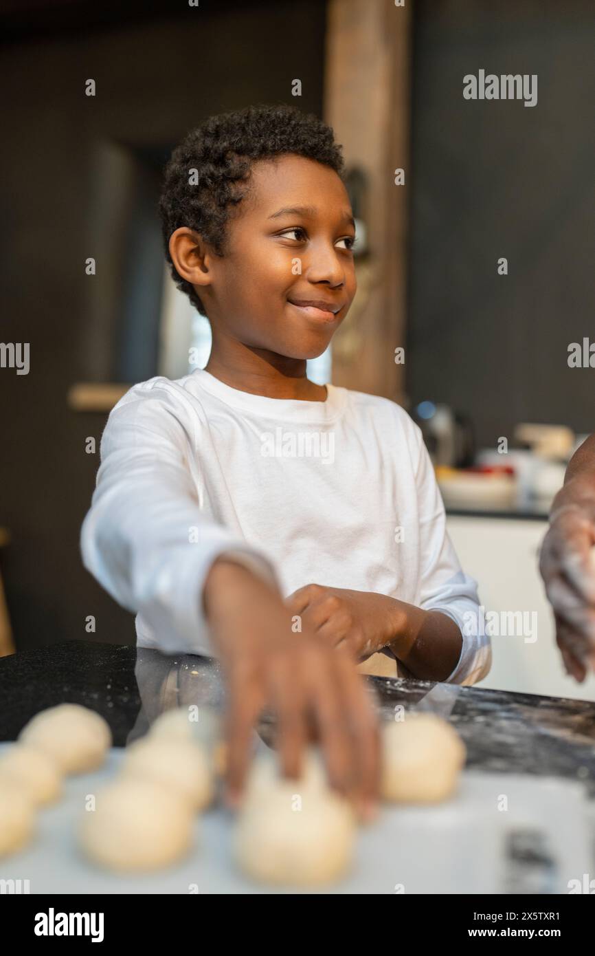 Boy baking cookies in kitchen Stock Photo - Alamy