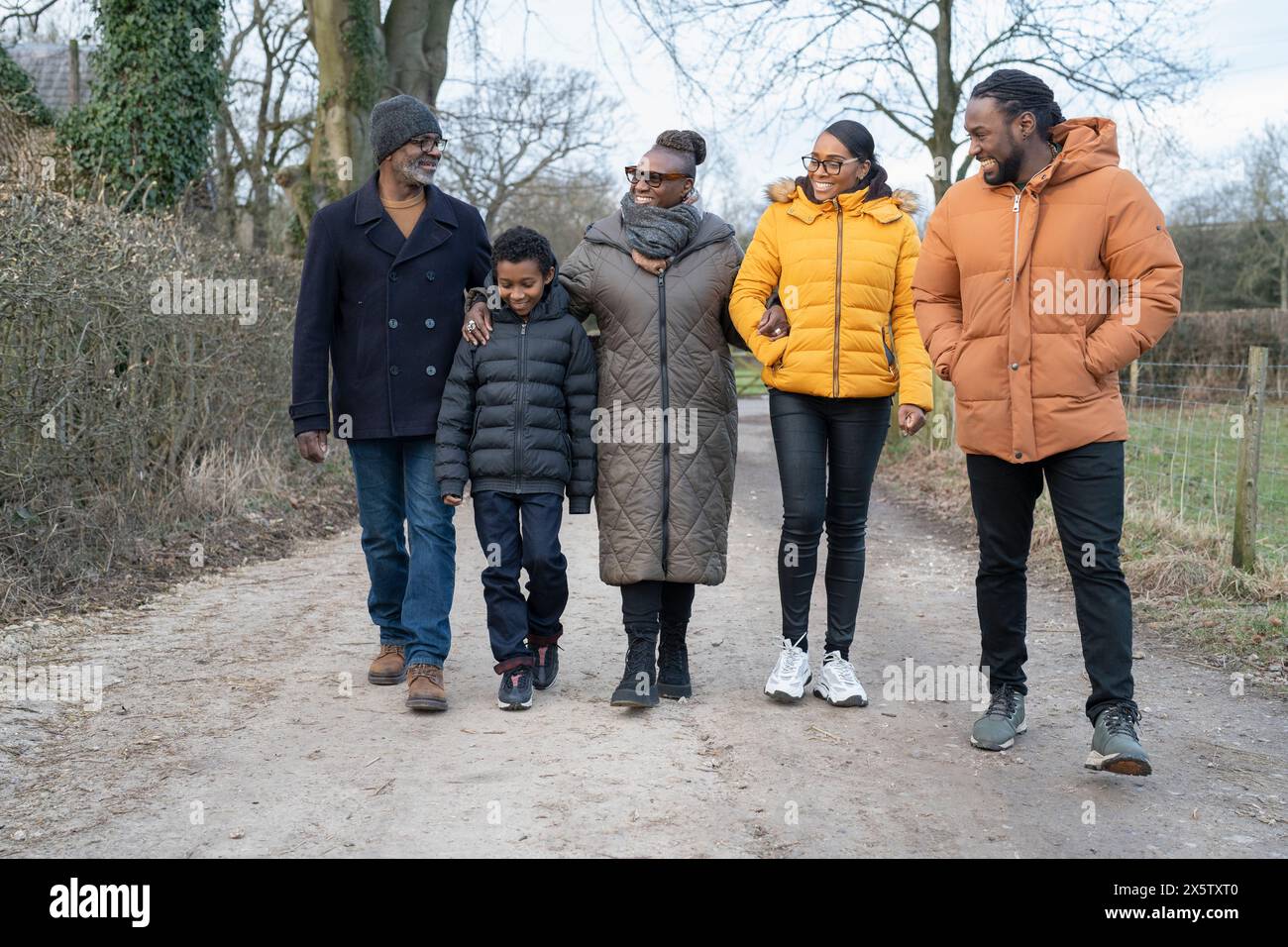 Three generation family walking together in rural area Stock Photo - Alamy