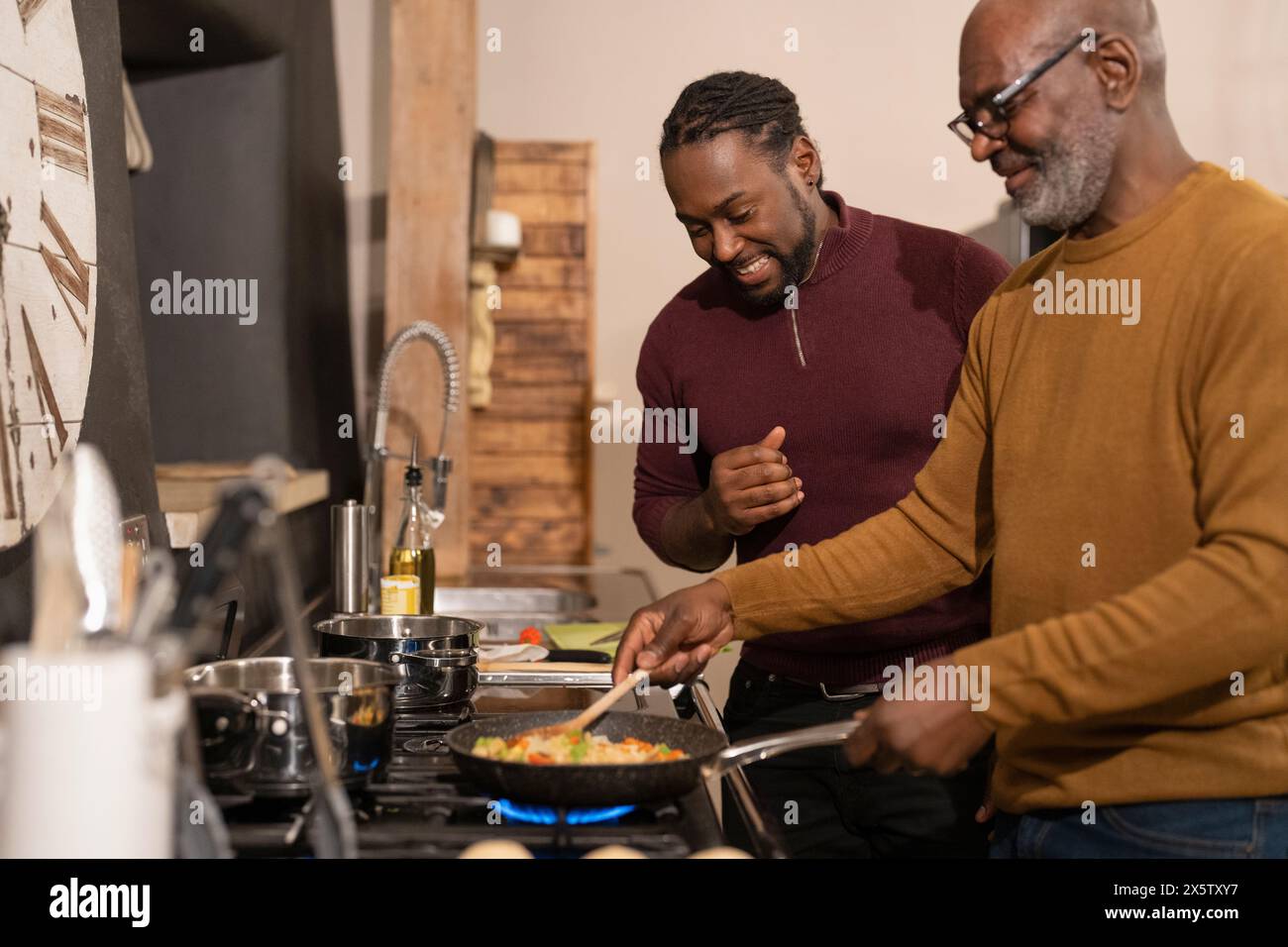 Two men preparing food in kitchen Stock Photo - Alamy