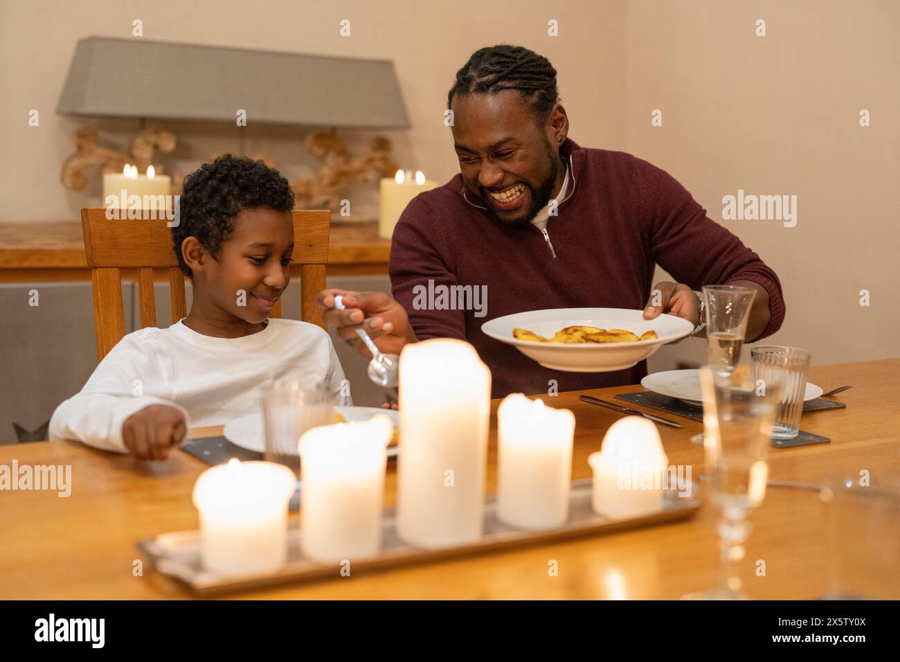 Father and son eating dinner together at home Stock Photo - Alamy
