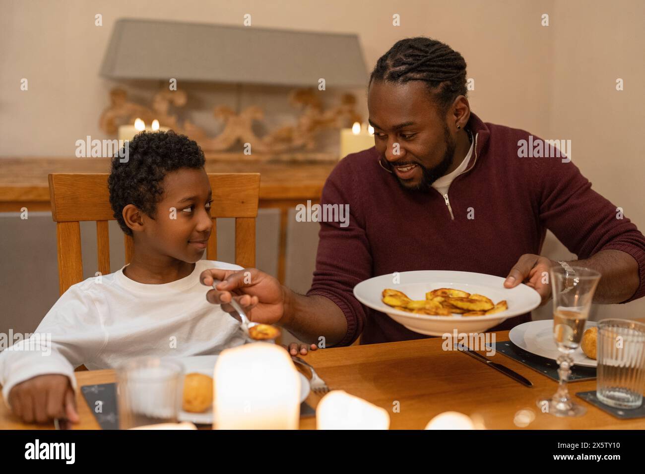 Father and son eating dinner together at home Stock Photo - Alamy