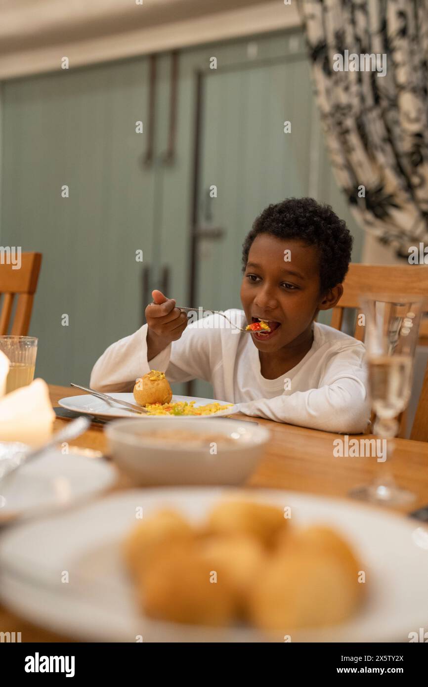 Boy eating dinner at home Stock Photo - Alamy