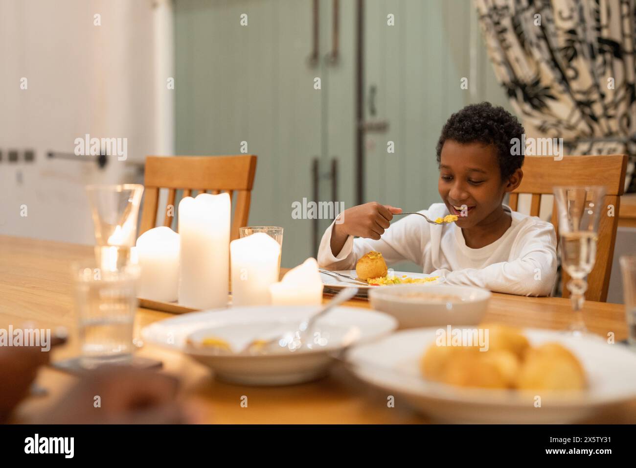 Boy eating dinner at home Stock Photo - Alamy