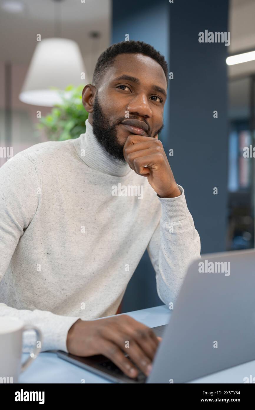 Young black man on laptop hi-res stock photography and images - Alamy